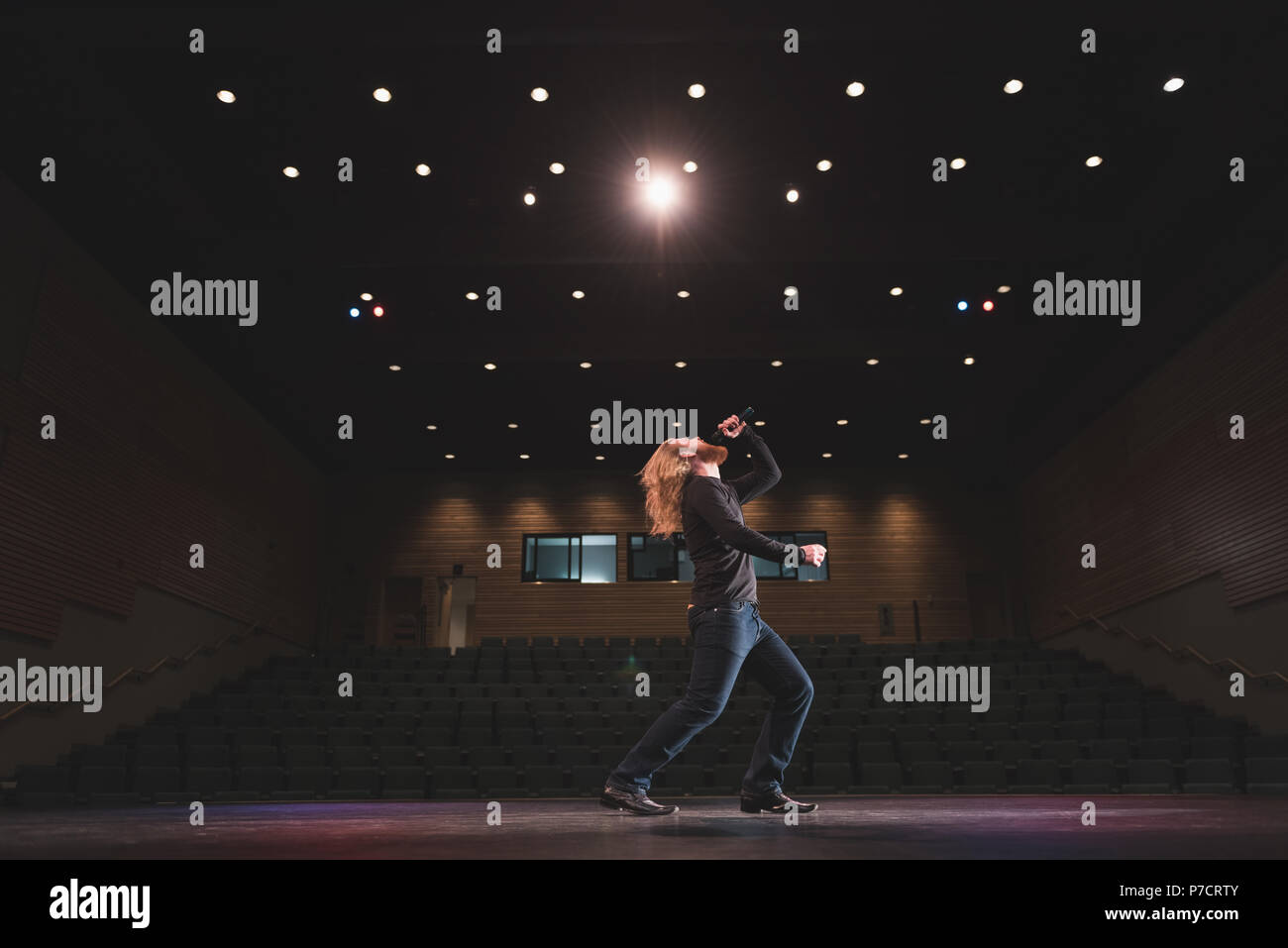 Male singer performing on stage Stock Photo - Alamy
