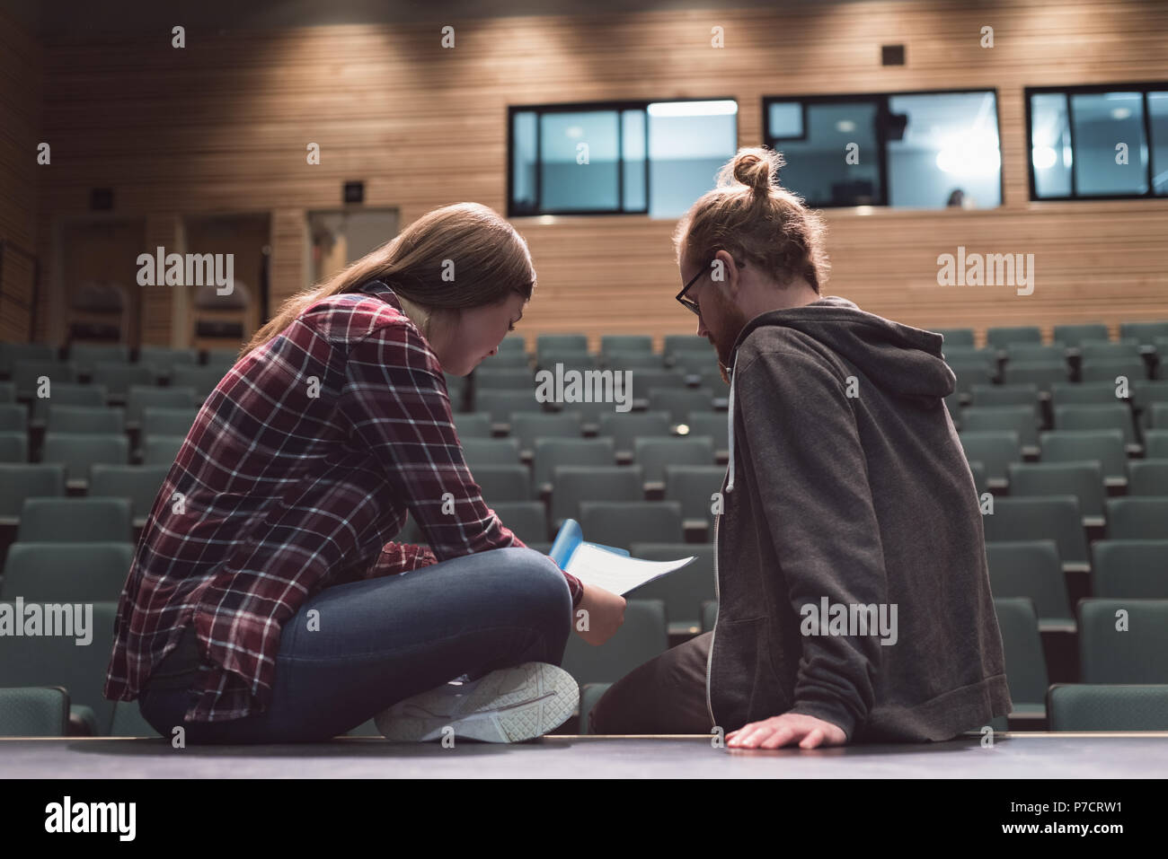 Male and female actress reading script on stage Stock Photo - Alamy