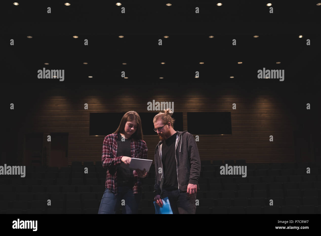 Male and female actress reading script on stage Stock Photo - Alamy