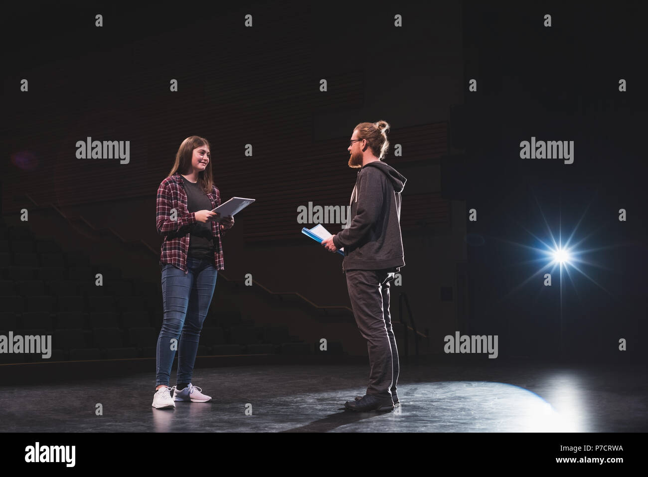 Male and female actress reading script on stage Stock Photo - Alamy