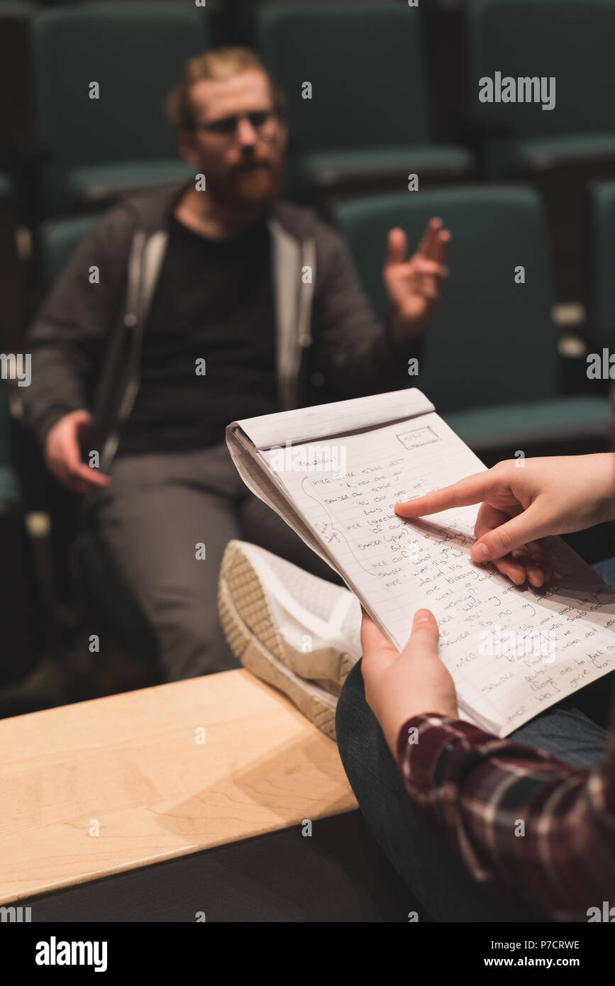 Female actress discussing script with male actor on stage Stock Photo ...
