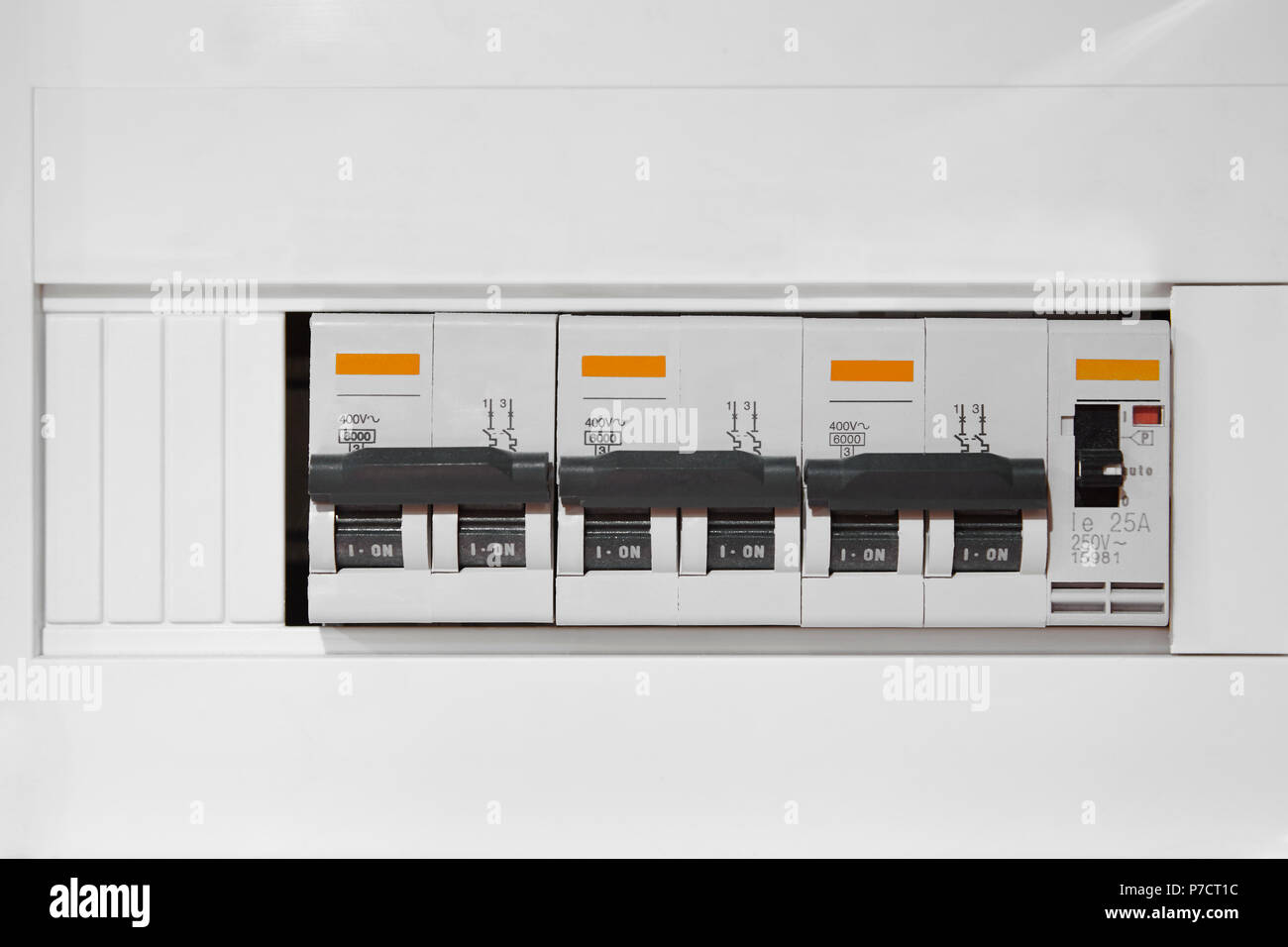 Electric switchboard control over a white wall. Electrical devices ...