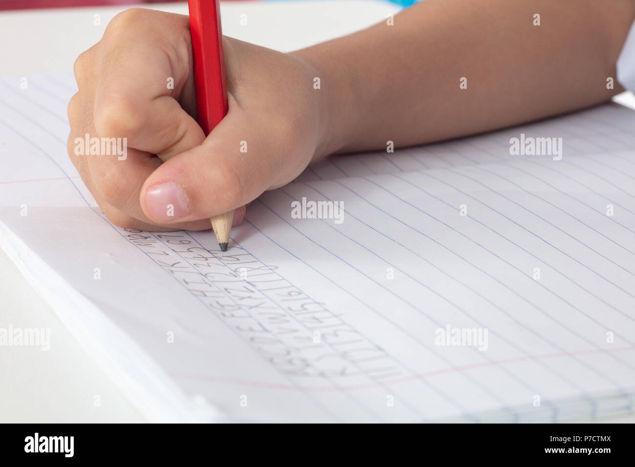 Children's hands holding pencil and doing homework at home Stock Photo ...