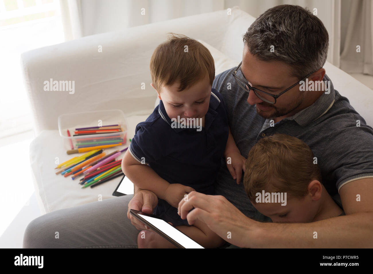 Father sons in sofa hi-res stock photography and images - Alamy