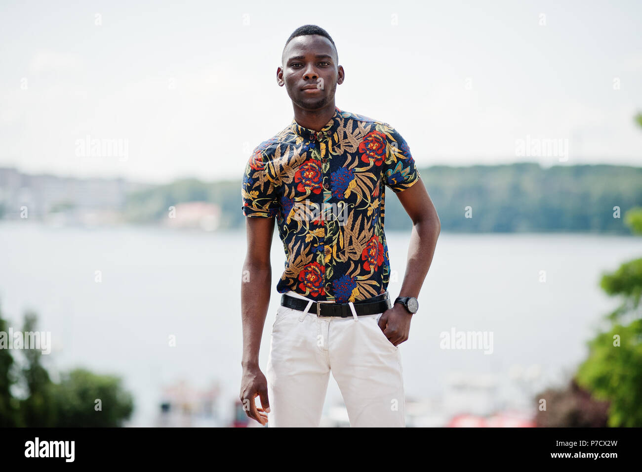 African man posed at street of city wear on shirt and white pants Stock ...