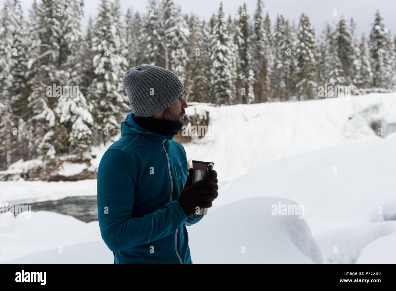 Man having coffee on a snowy landscape Stock Photo - Alamy