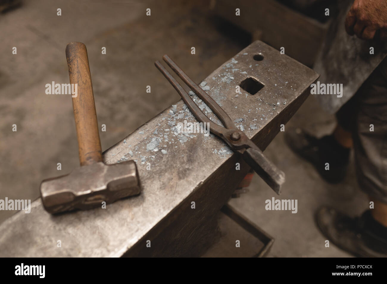 Hammer and pliers on anvil in workshop Stock Photo - Alamy