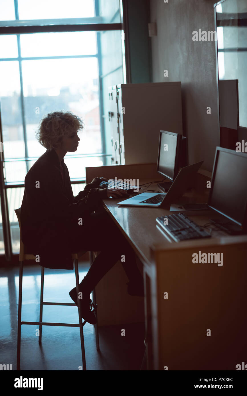 Young woman working on desktop hi-res stock photography and images - Alamy
