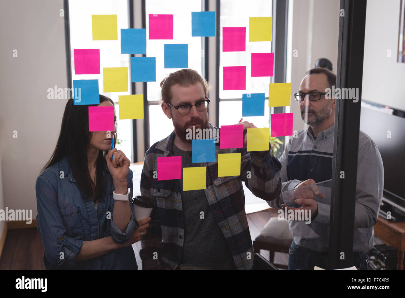 Business colleagues writing on sticky notes Stock Photo - Alamy