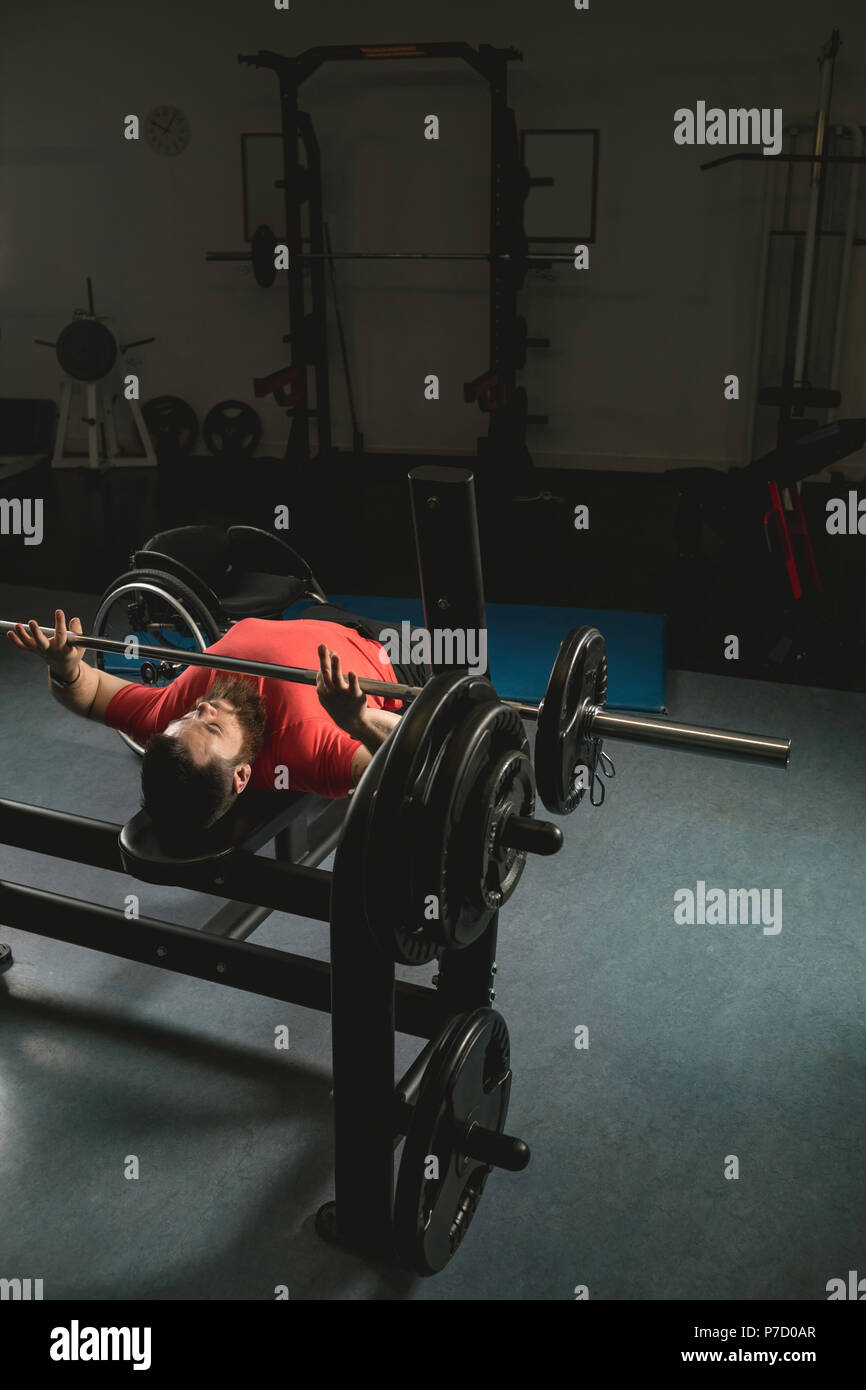 Handicapped man doing barbell bench pressing while exercising Stock ...
