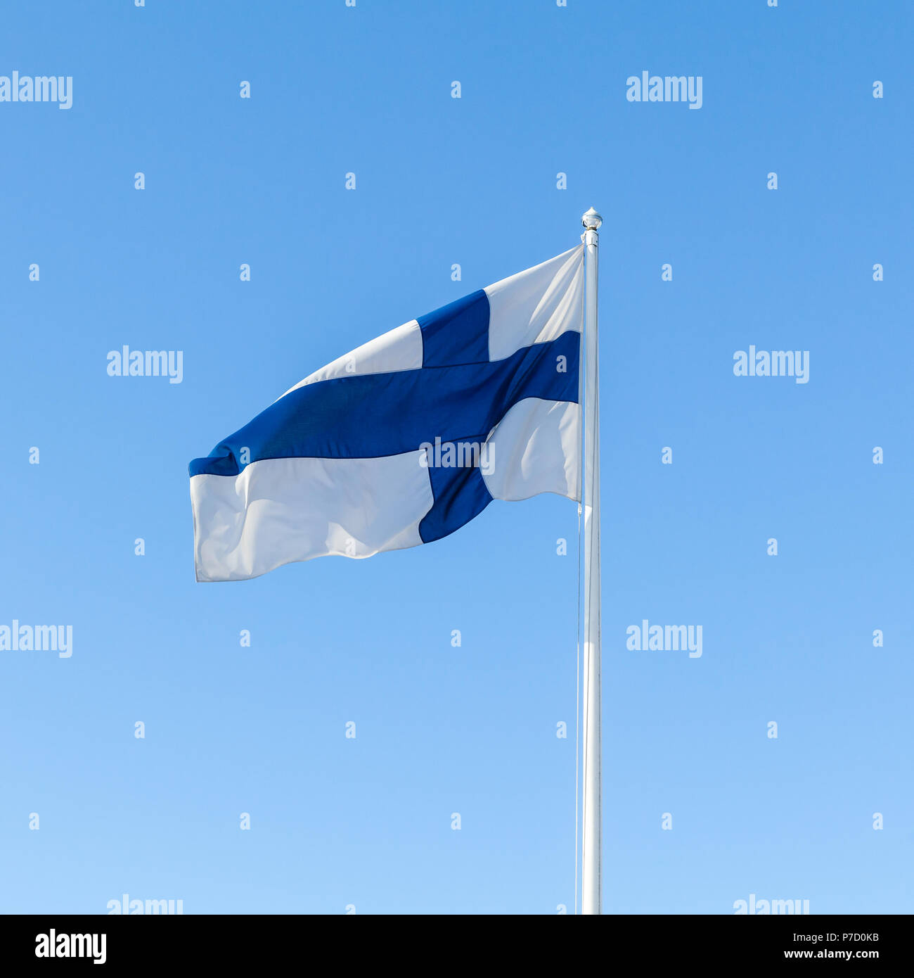 Flag of Finland waving over blue sky background Stock Photo - Alamy