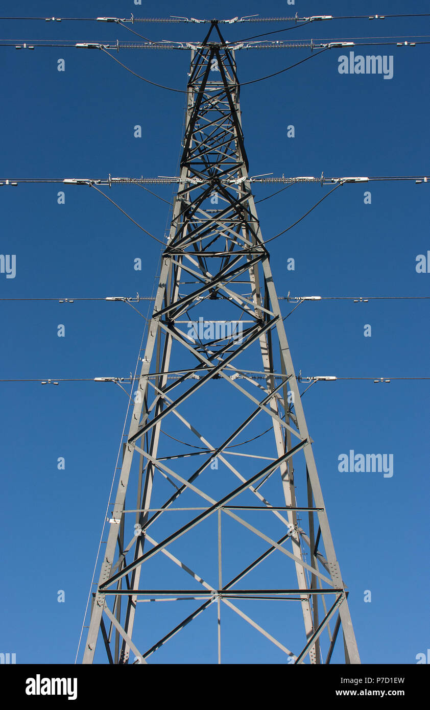 Electricity pylon against blue sky Stock Photo - Alamy