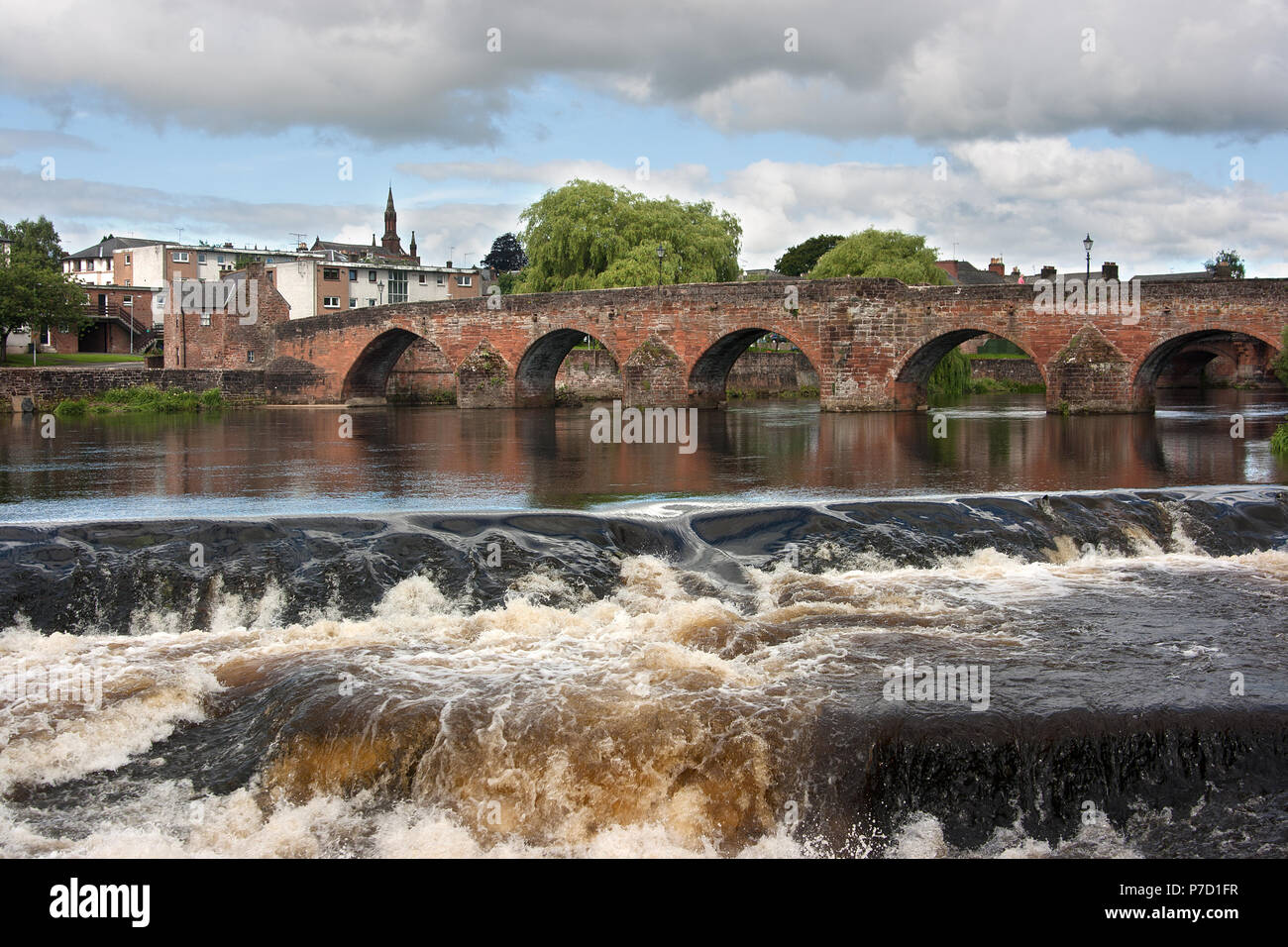 Devogilla Bridge (15th century) over the river Nith with weir in ...