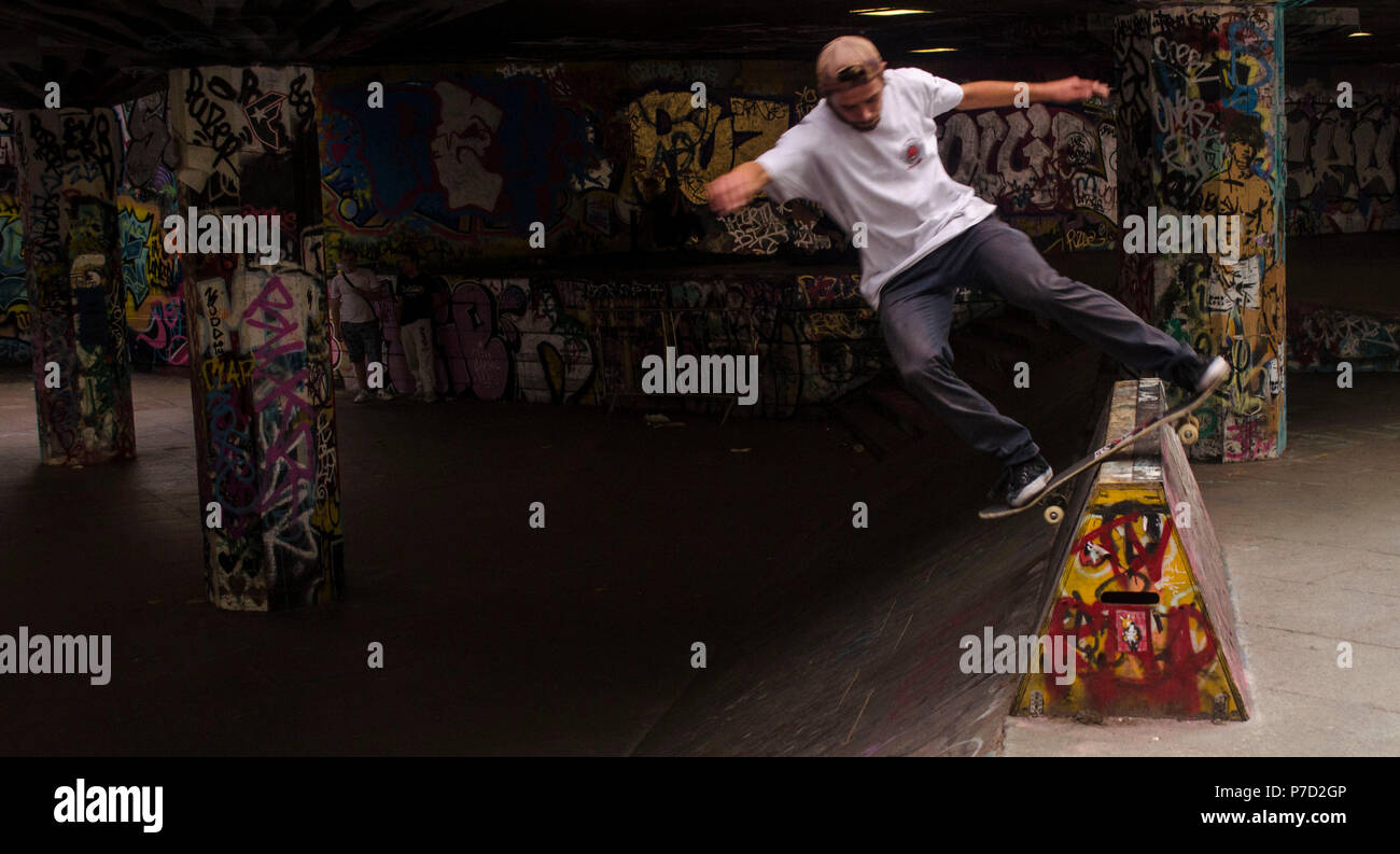 A young boy doing a balancing act on a skateboard at the South Bank ...