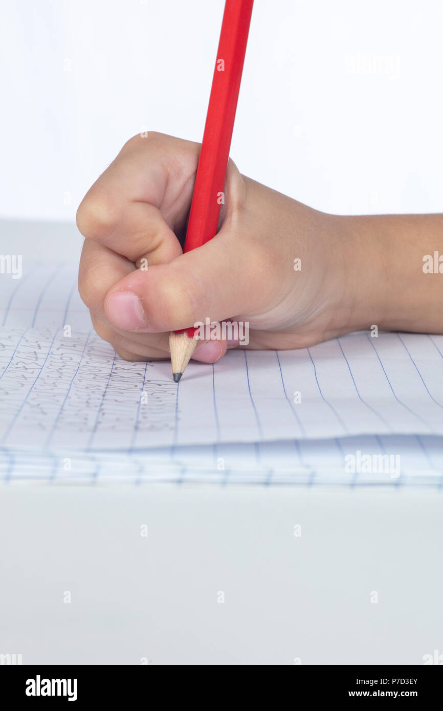 Children's hands holding pencil and doing homework in isolated white ...