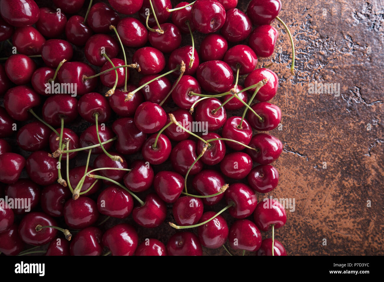 Cherry Background. Sweet organic cherries on old copper table. Copy ...