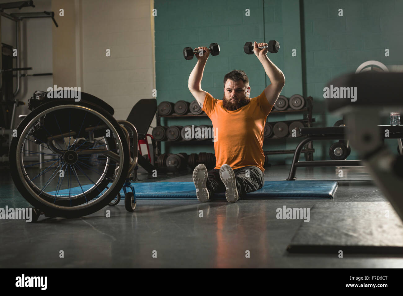 Handicapped man exercising with dumbbell Stock Photo - Alamy