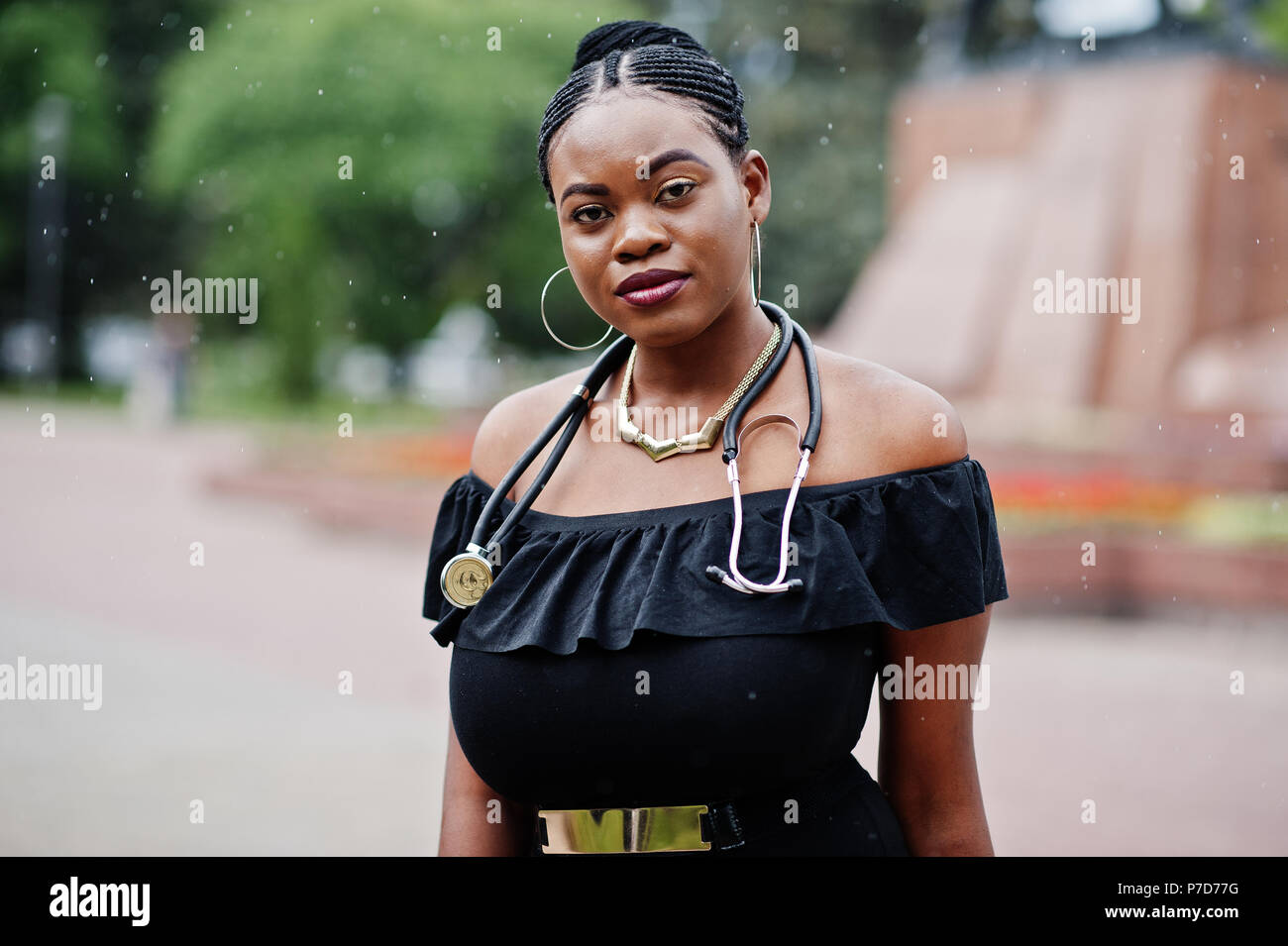 African american doctor female at black dress with stethoscope posed ...