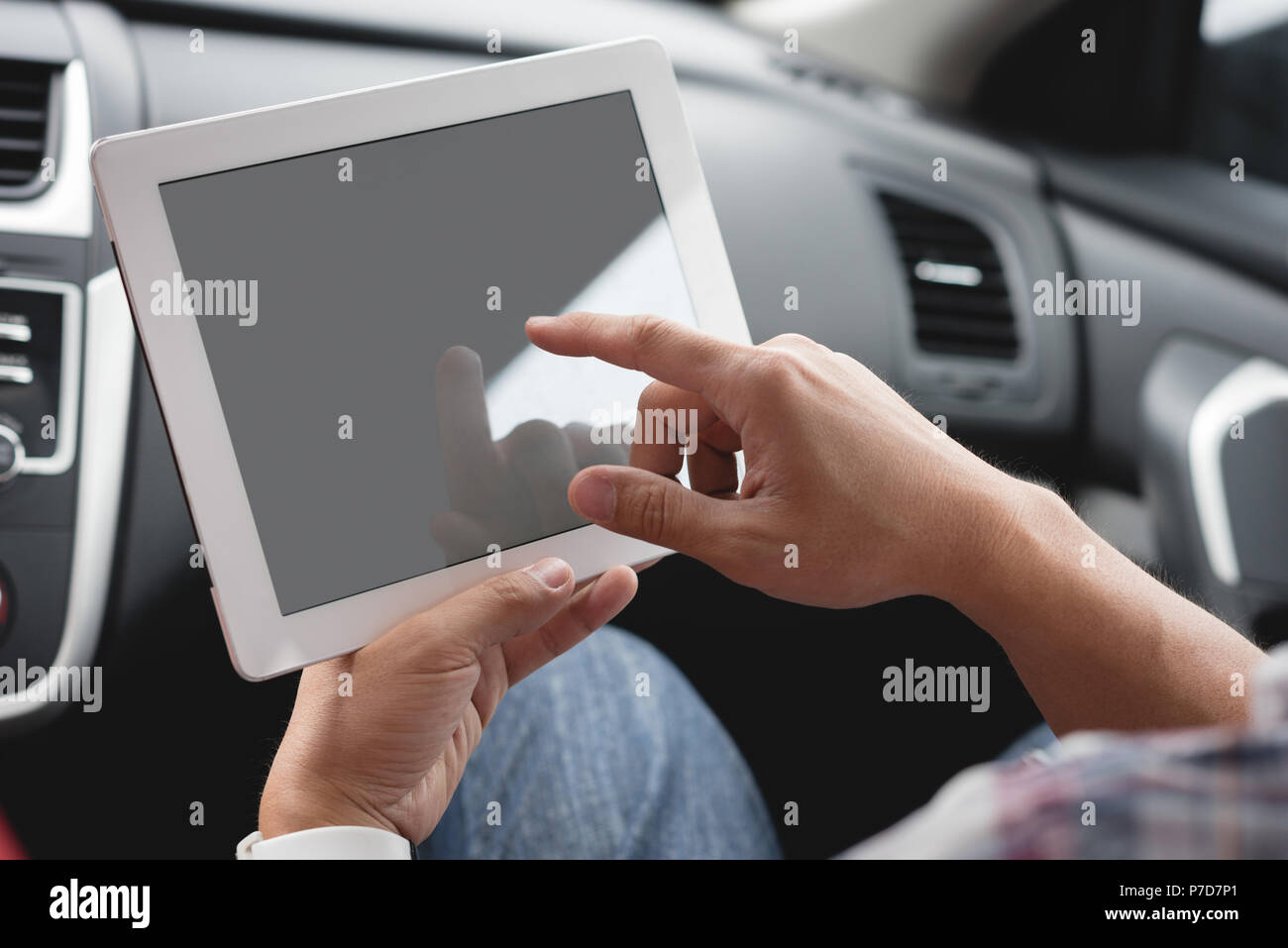 Man using digital tablet in car Stock Photo - Alamy
