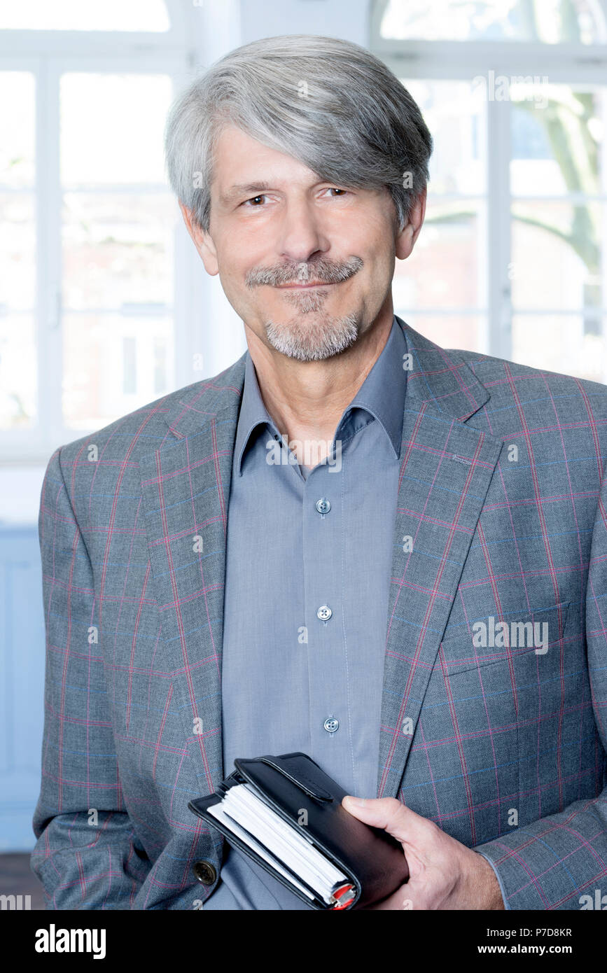 Man with calendar in front of his office window Stock Photo - Alamy
