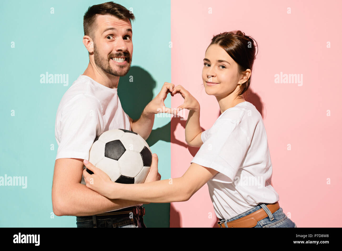 The young fans celebrating on blue and pink trendy colors Stock Photo ...