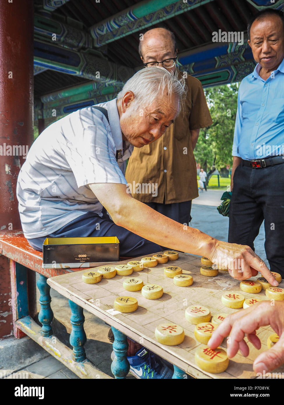 Older man playing traditional Chinese chess in the long corridor of the ...