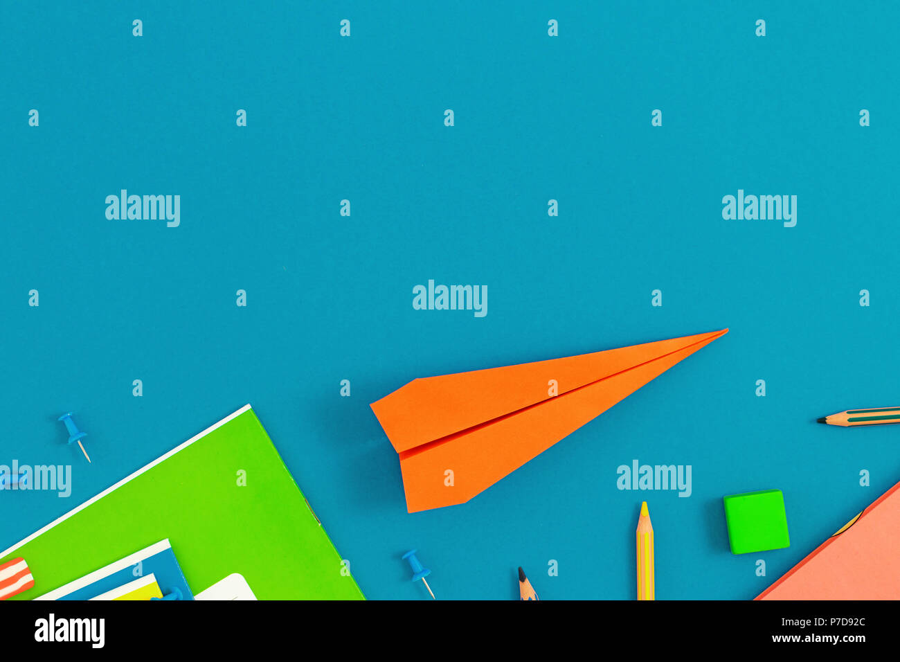 Flat lay back to school concept with paper airplane and school supplies ...
