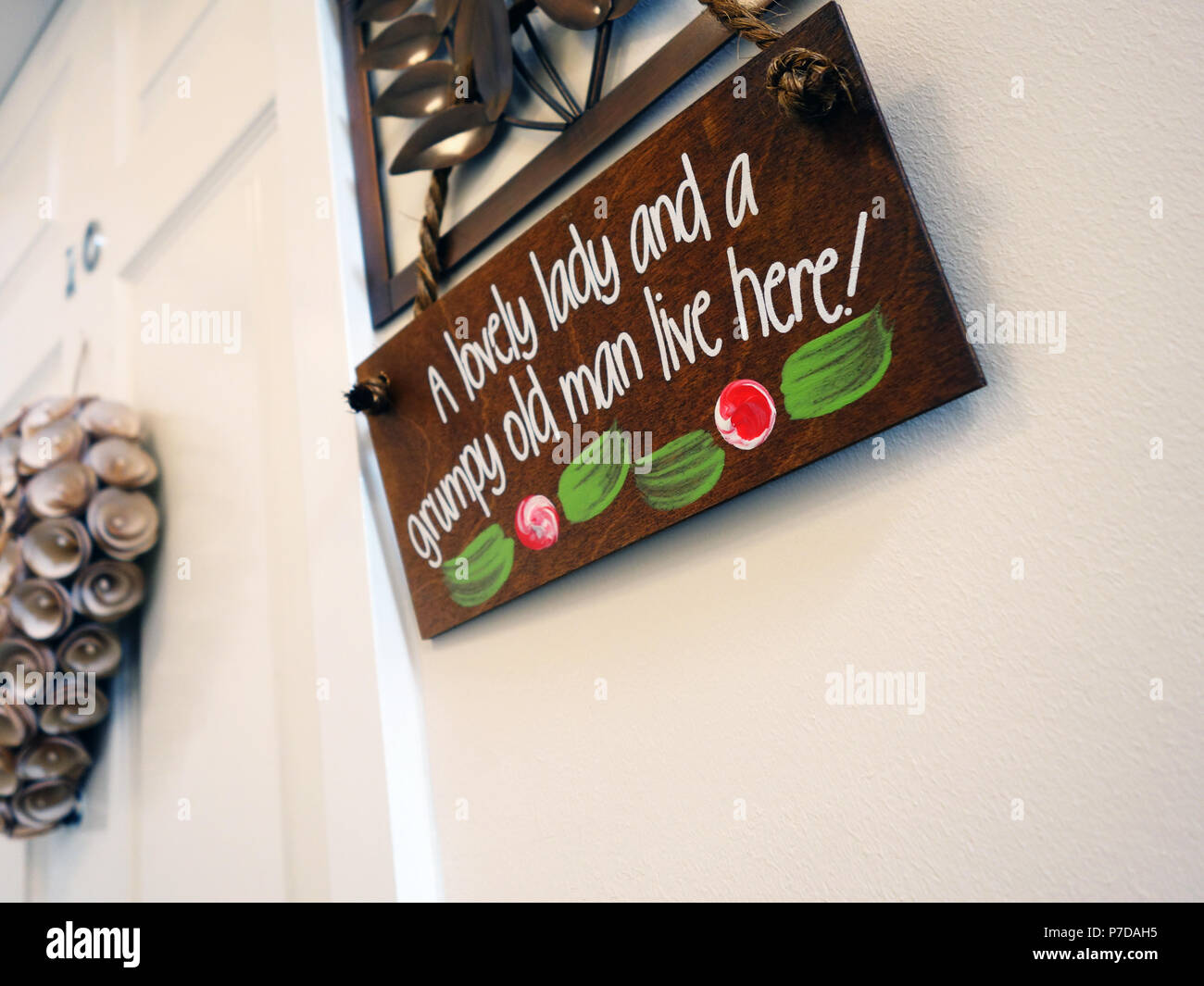 A lovely lady and a grumpy old man live here! sign hangs near front ...