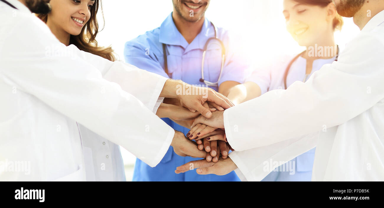 Doctors and nurses stacking hands. concept of mutual aid Stock Photo ...