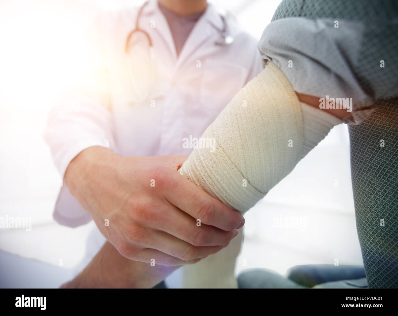 Doctor applying bandage to patients hand and wrist hi-res stock ...