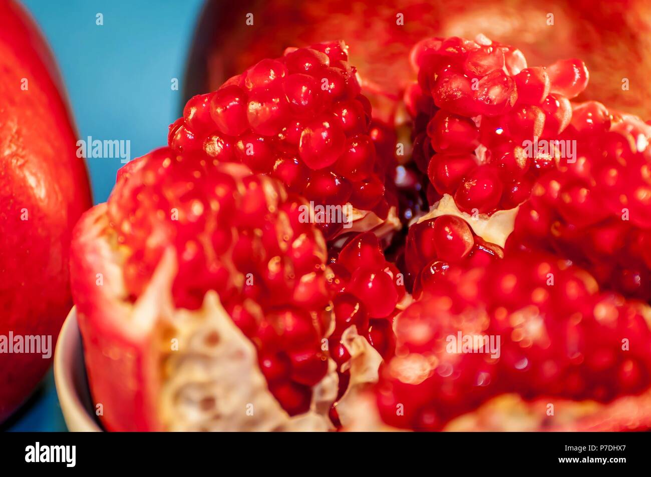 Beautiful image of ripe pomegranate open with red seeds close up ...