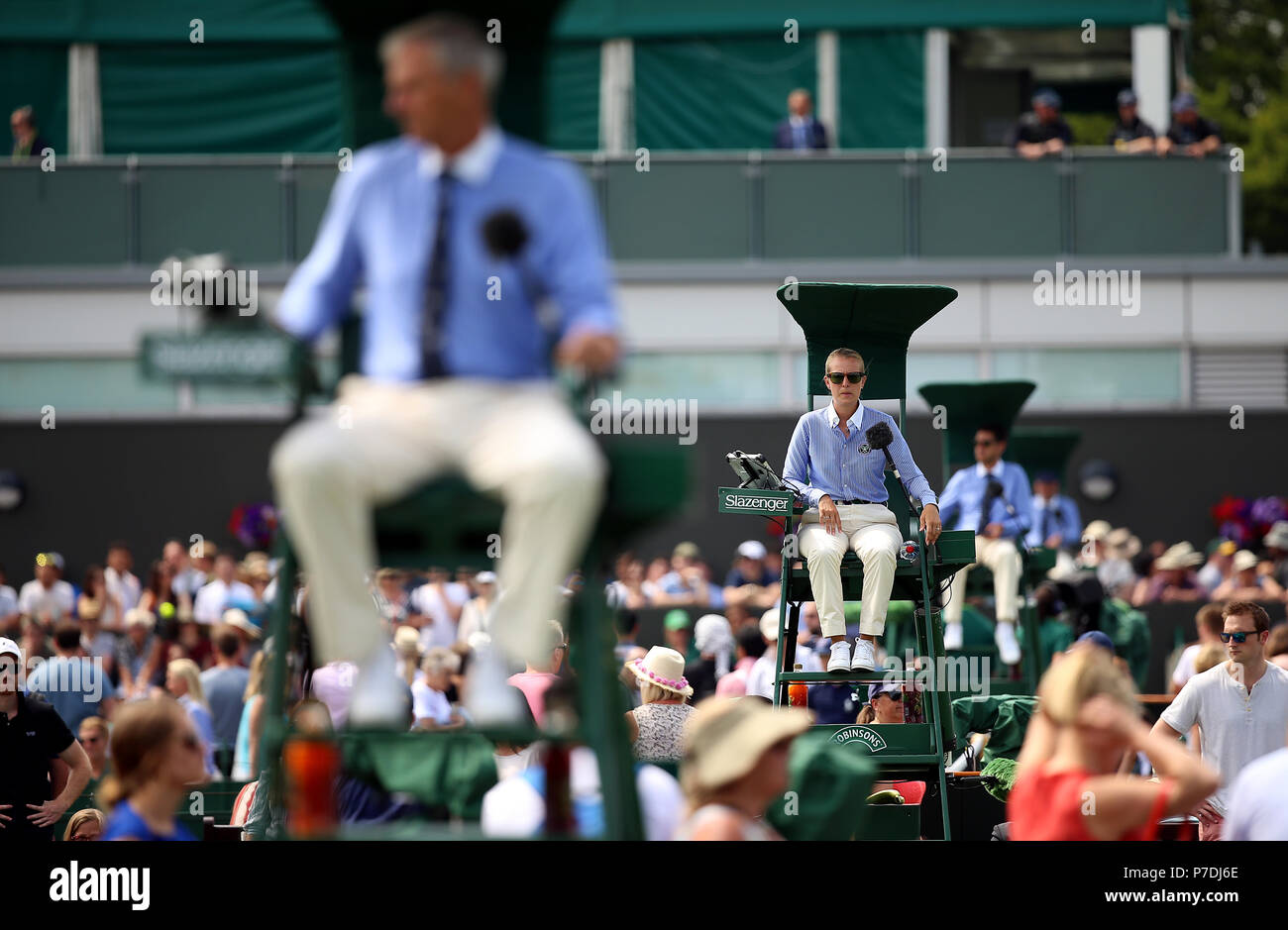Umpires keep an eye on the action on the outside courts on day four of ...