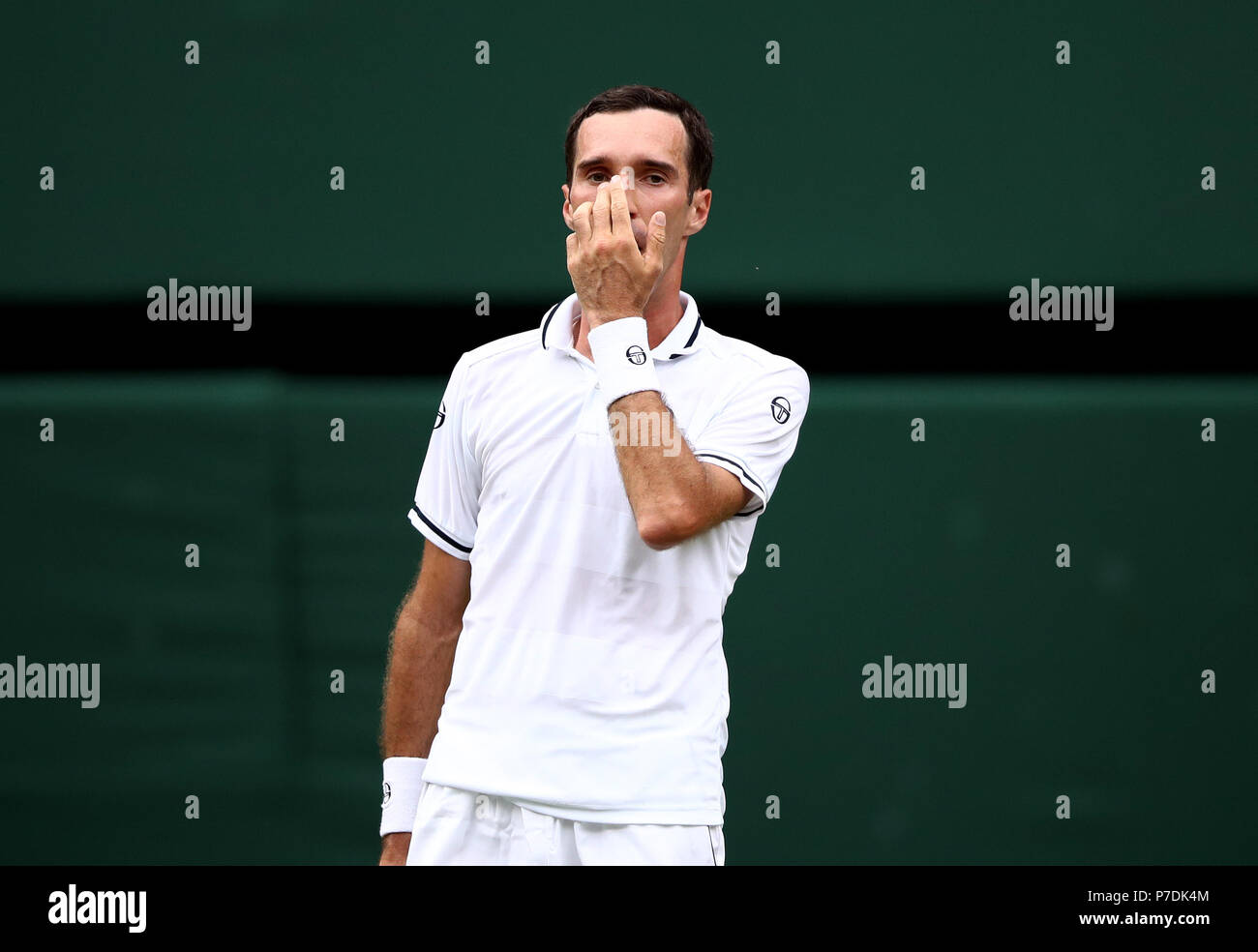 Mikhail Kukushkin reacts on day four of the Wimbledon Championships at ...