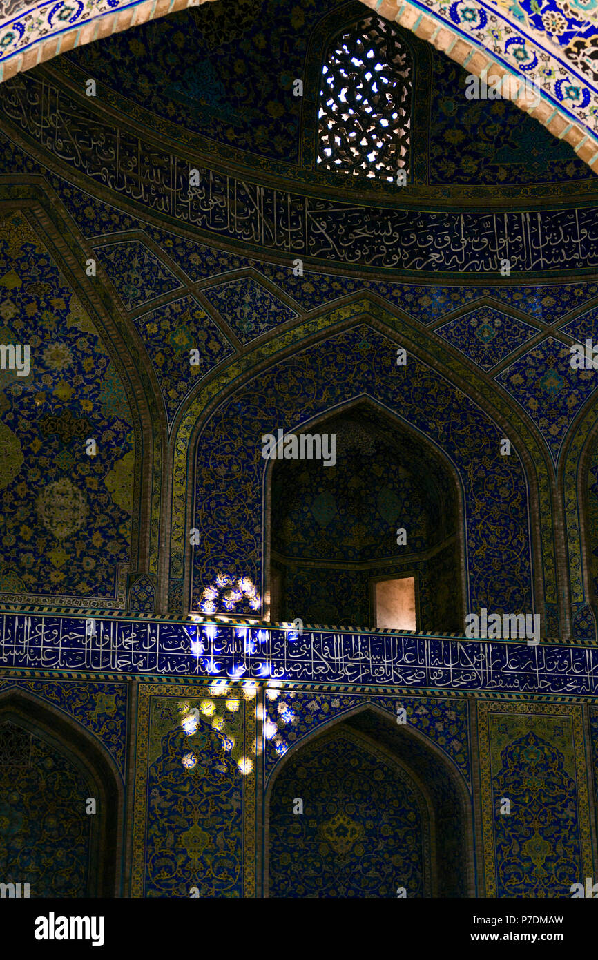 Sun light beams shine through a lattice window high up in the stunning ...