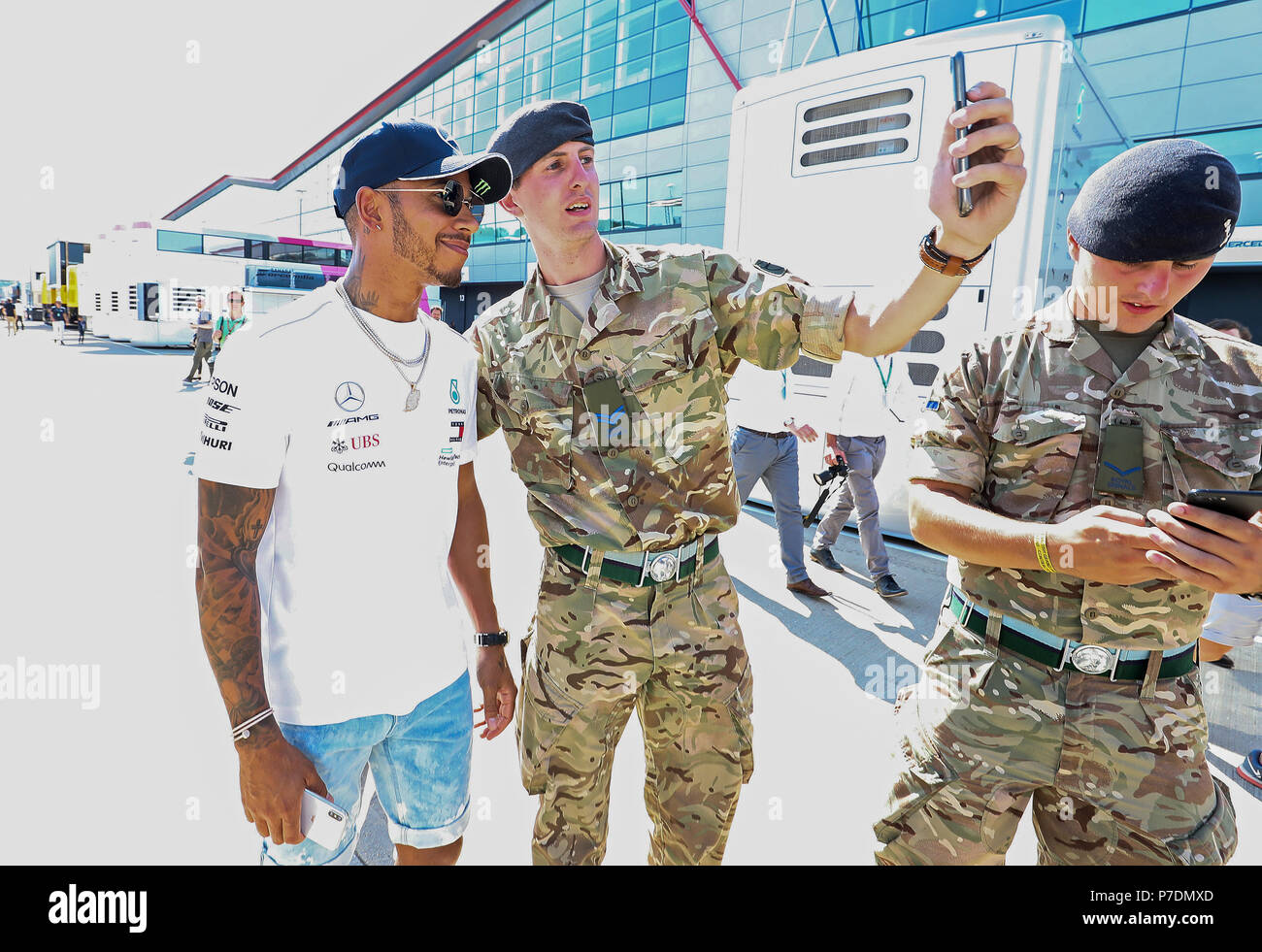 Mercedes driver Lewis Hamilton poses for photographs in the paddock at ...