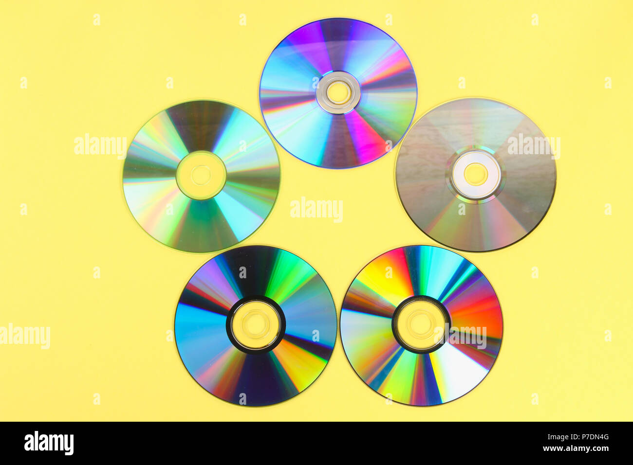 Piles of old and dirty CDs,DVD on pastel background. Used and dusty ...