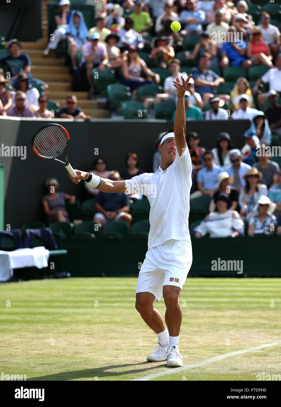 Kei Nishikori serves on day four of the Wimbledon Championships at the ...