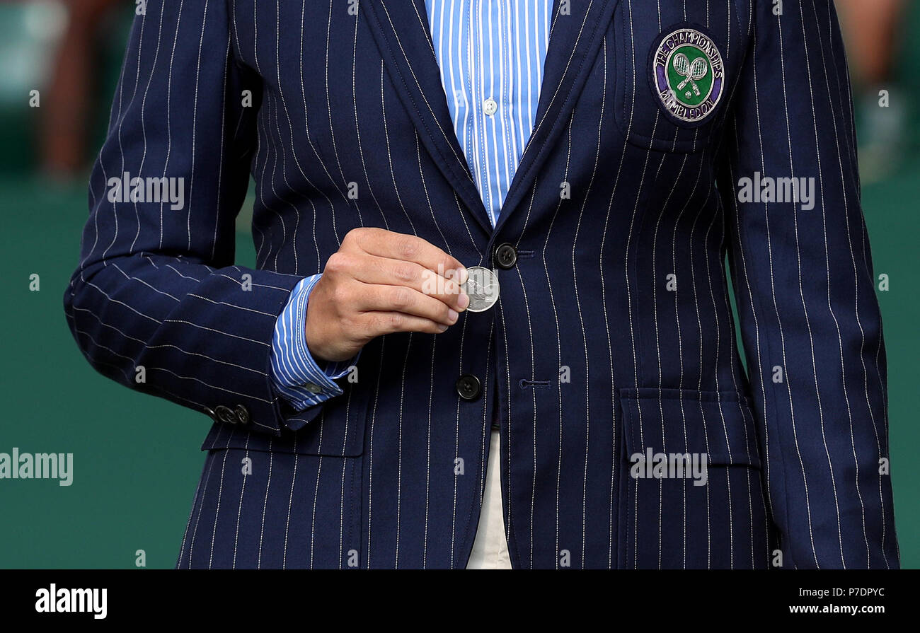 An umpire holds a coin ready for the coin toss on day four of the ...
