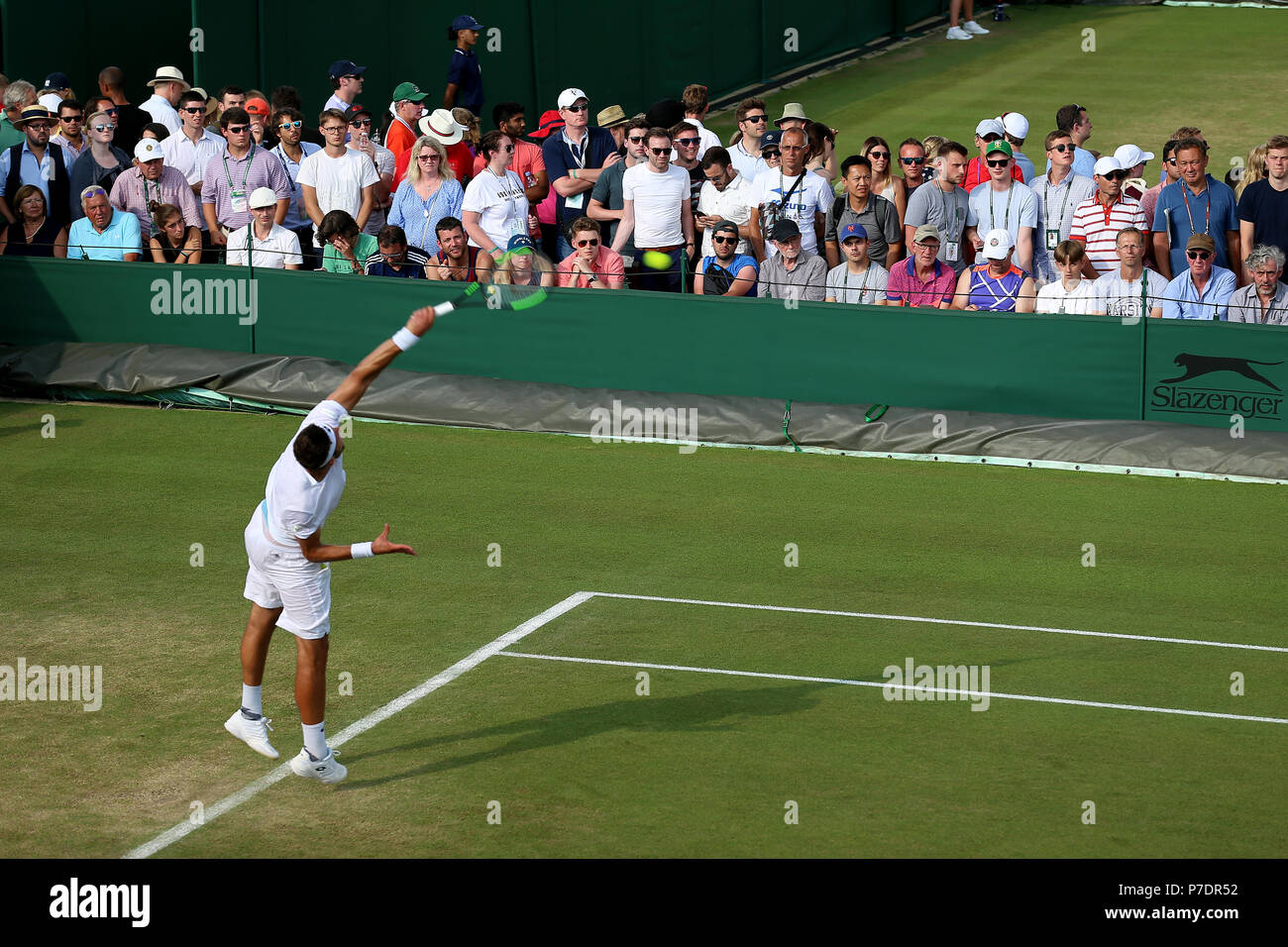 Spectators keep an eye on the action on the outside courts on day four ...