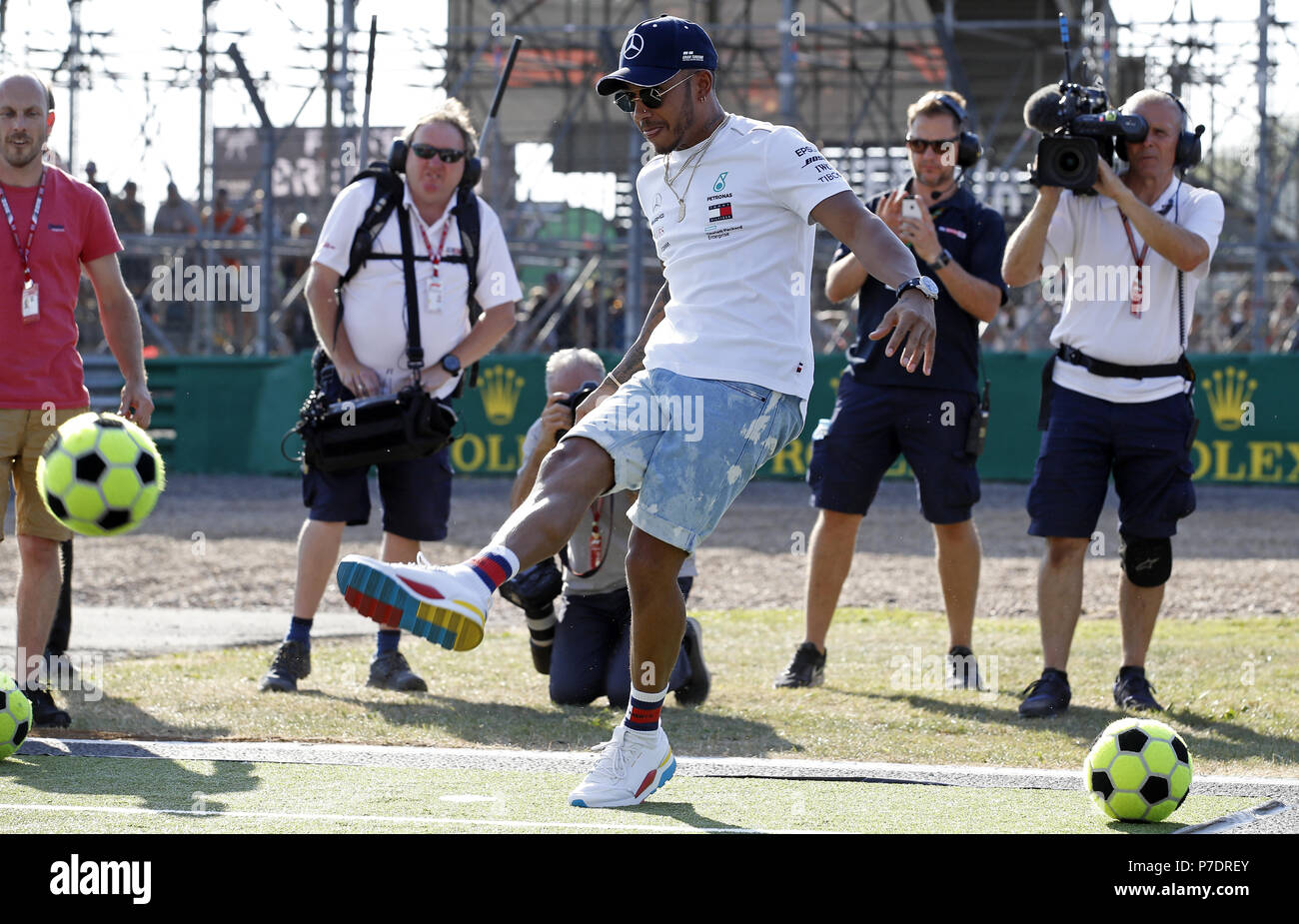 Mercedes' Lewis Hamilton kicks a football in front of the media during ...