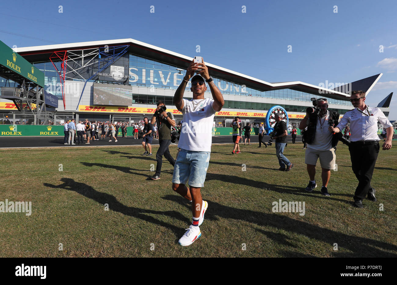 Mercedes' Lewis Hamilton takes a picture of the crowd during the ...
