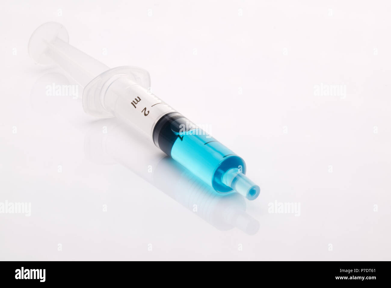 Clear plastic syringe containing blue liquid (Copper sulfate solution ...