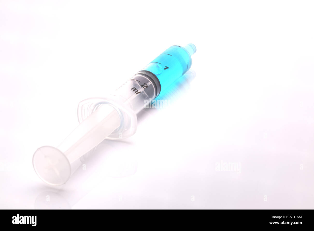 Clear plastic syringe containing blue liquid (Copper sulfate solution ...