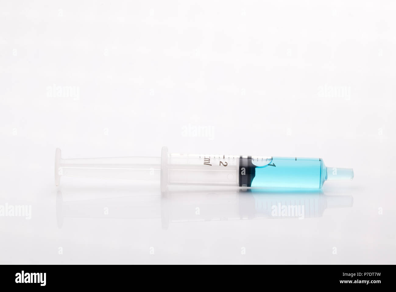 Clear plastic syringe containing blue liquid (Copper sulfate solution ...