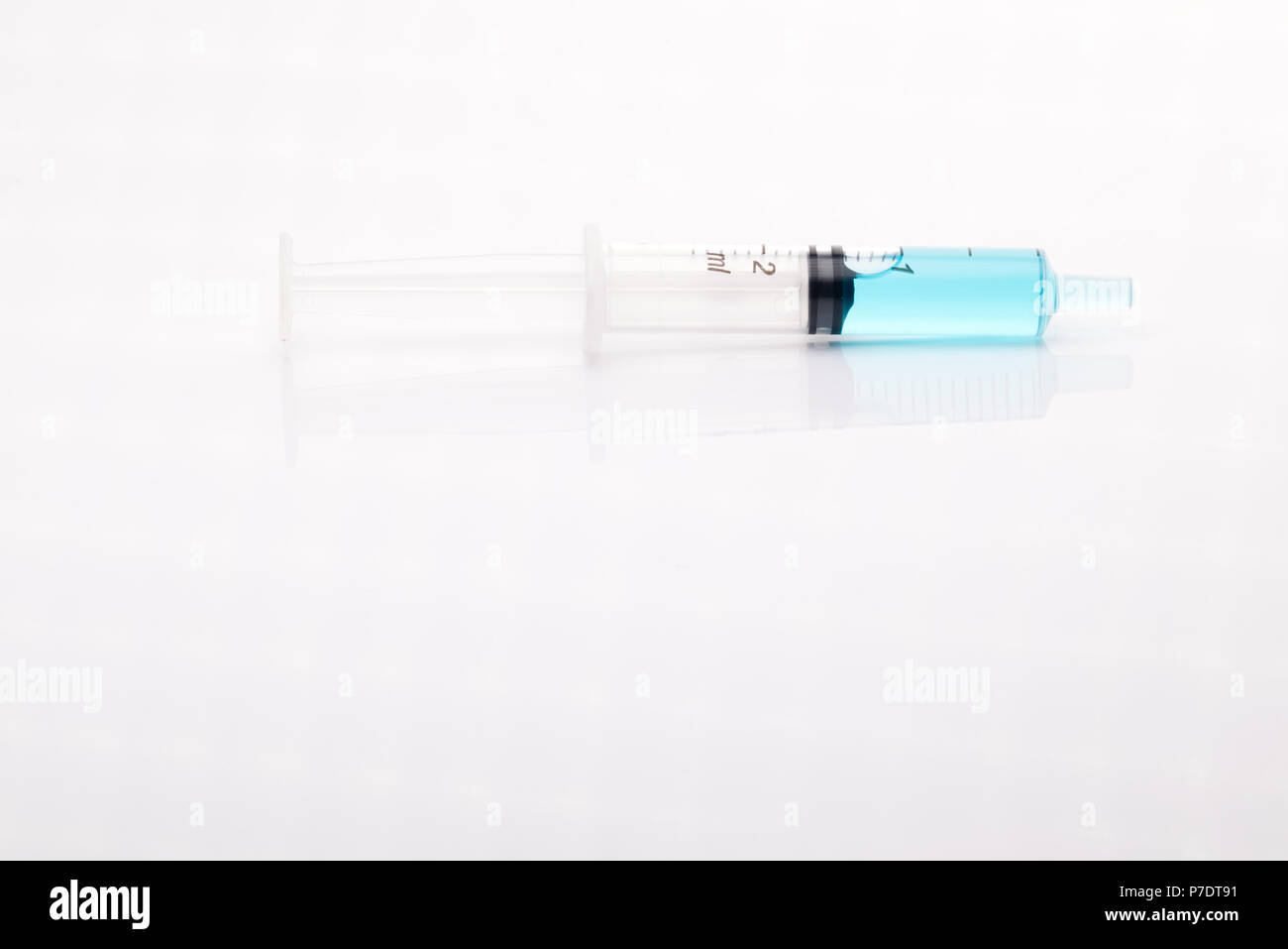 Clear plastic syringe containing blue liquid (Copper sulfate solution ...