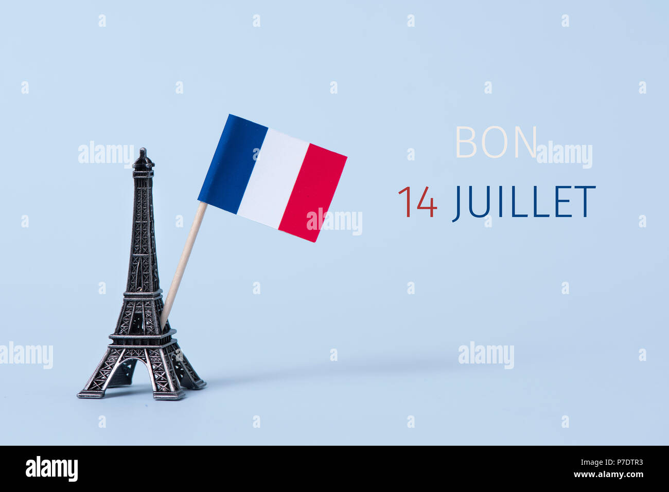a miniature of the Eiffel Tower, a french flag and the text bon 14 ...