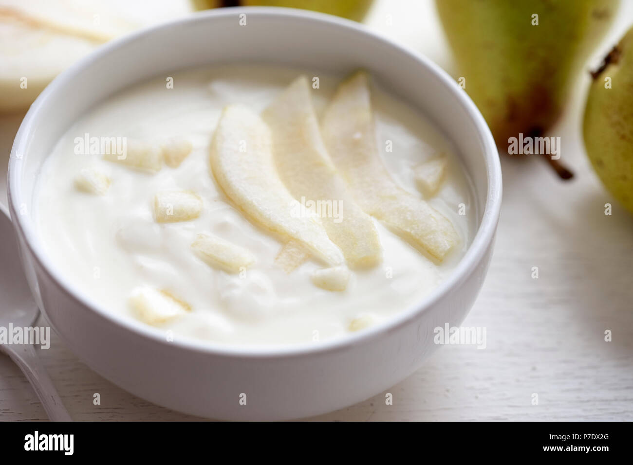 Pear yoghurt in bowl Stock Photo - Alamy