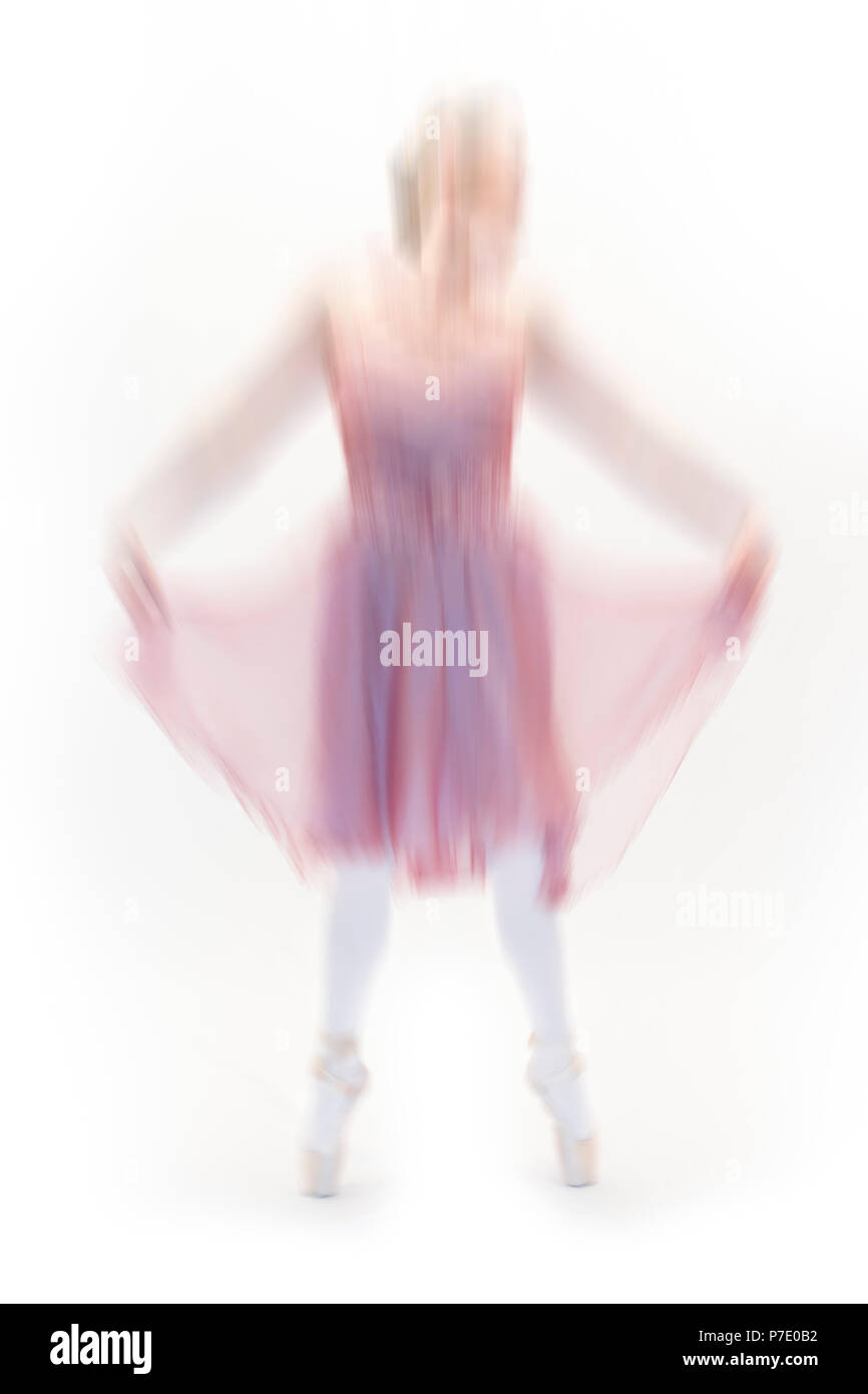Blurred young ballet dancer posing on white background Stock Photo - Alamy