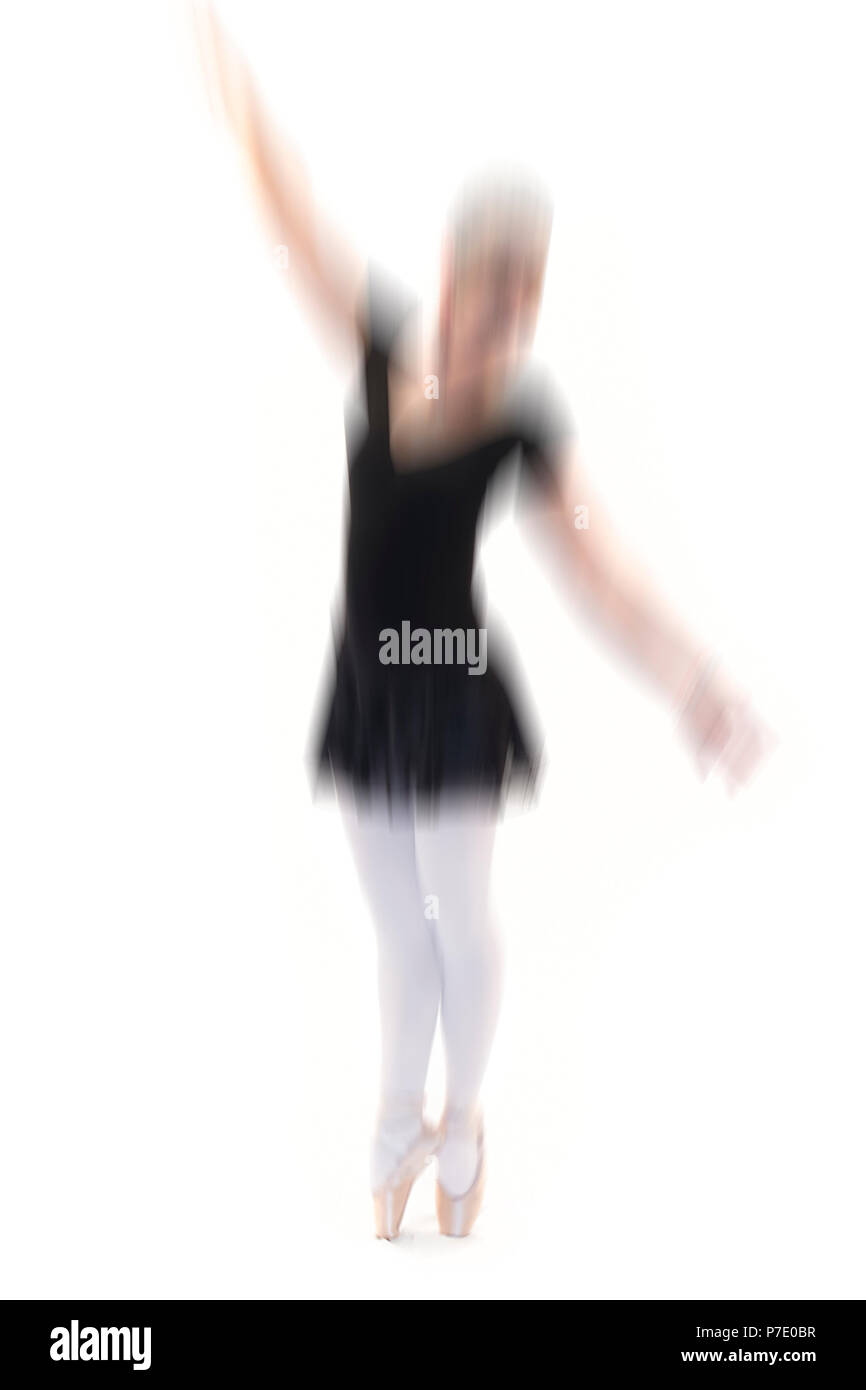Blurred young ballet dancer posing on white background Stock Photo - Alamy