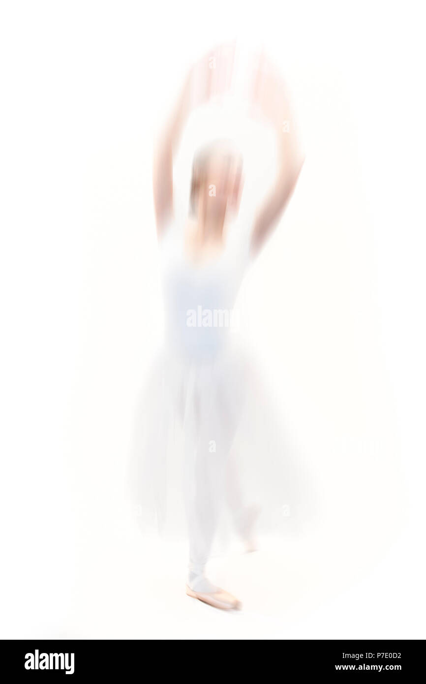 Blurred young ballet dancer posing on white background Stock Photo - Alamy